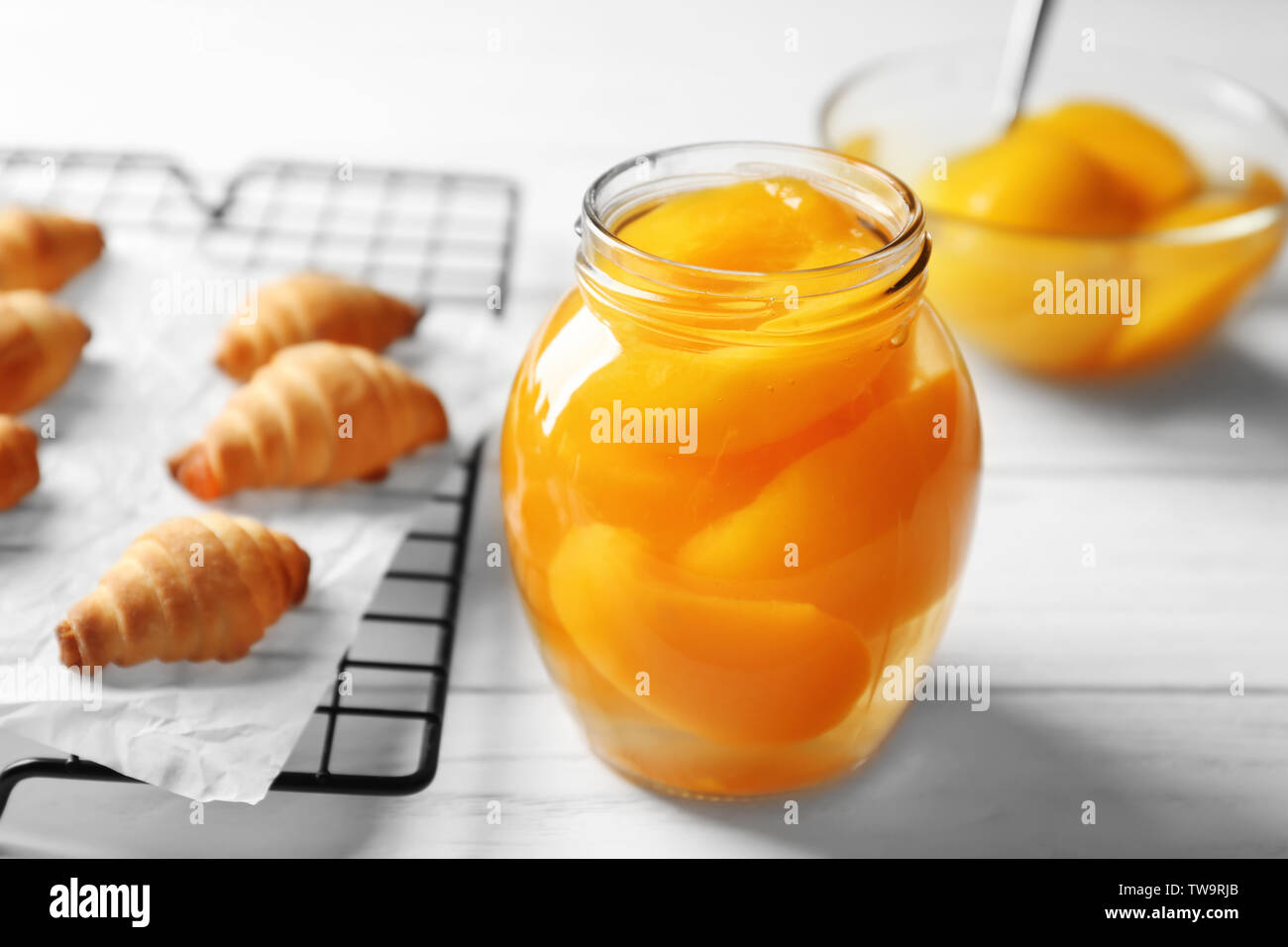 Jar with pickled apricots on table Stock Photo - Alamy