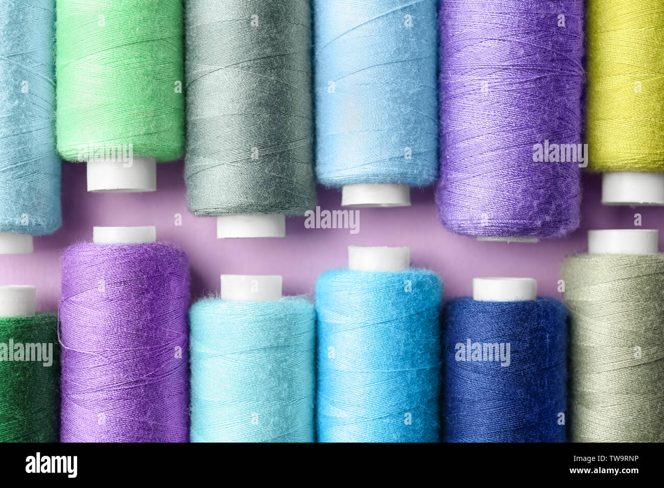 Set of sewing threads on color background Stock Photo - Alamy