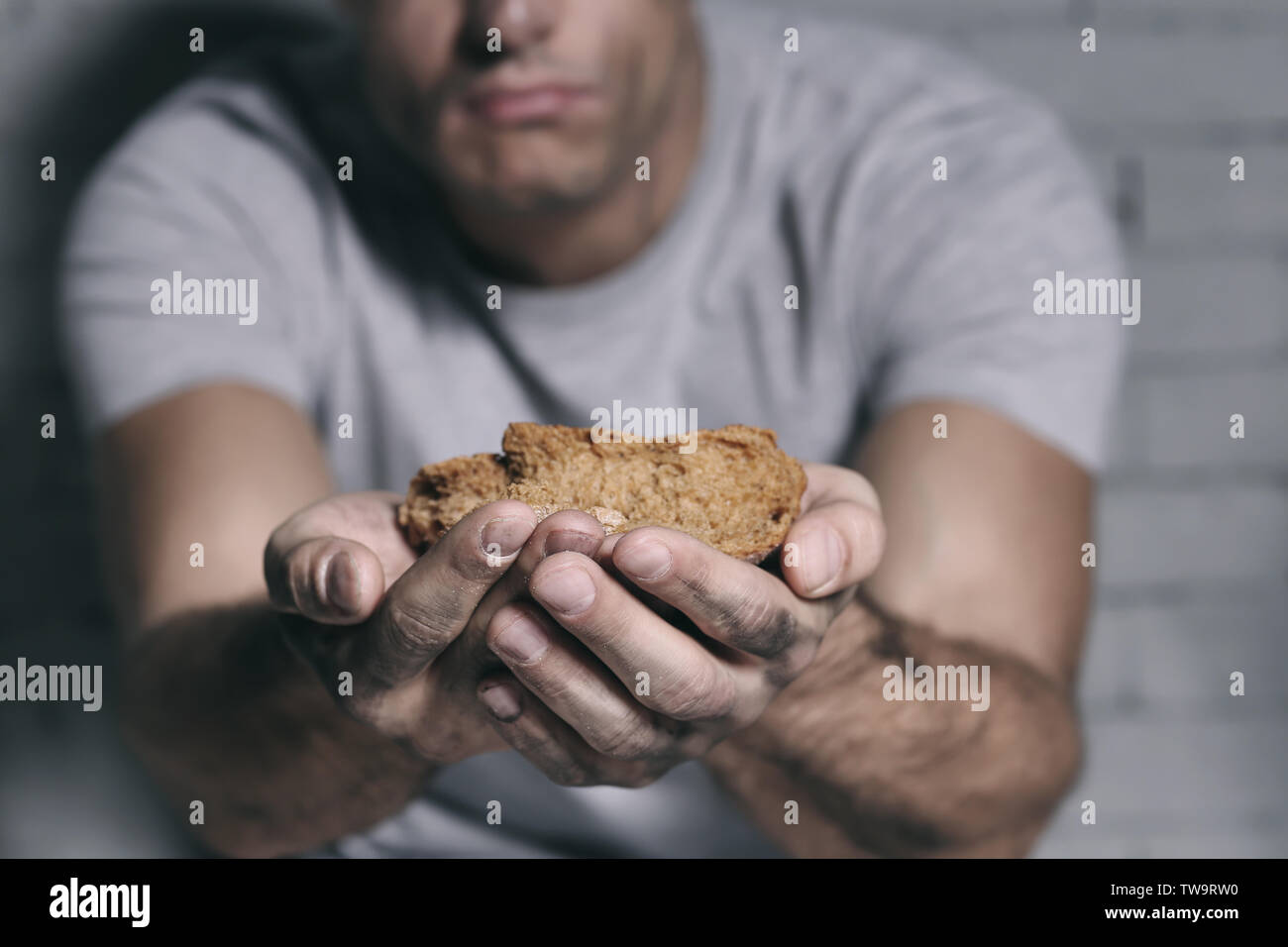 Homeless poor man with piece of bread, closeup Stock Photo - Alamy