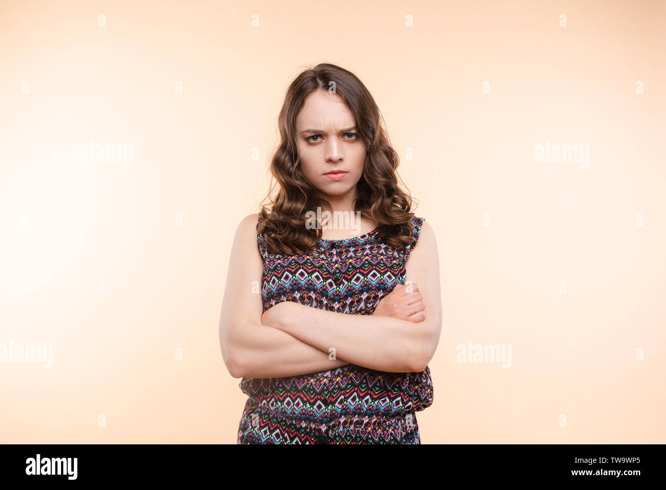 Angry or sad girl with folded arms Stock Photo - Alamy