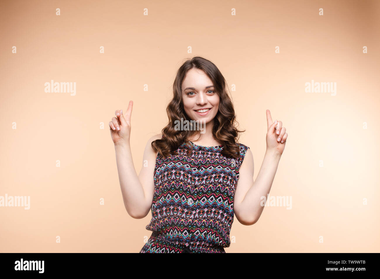 Beautiful brunette woman laughing pointing hi-res stock photography and ...