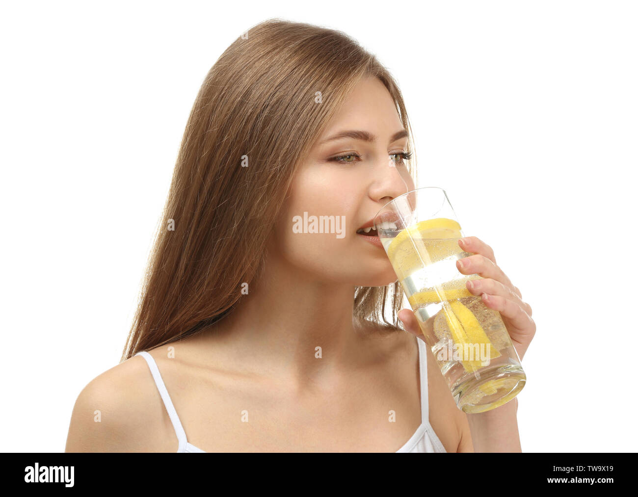 Beautiful young woman drinking fresh lemonade on white background Stock ...