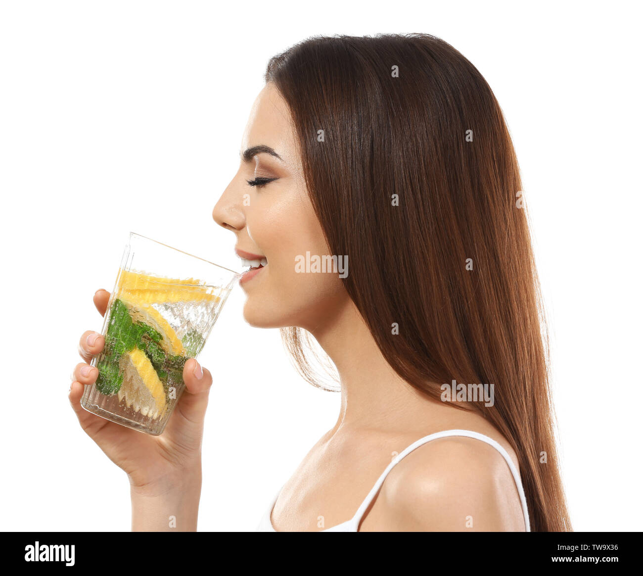 Beautiful young woman drinking lemonade on white background Stock Photo ...