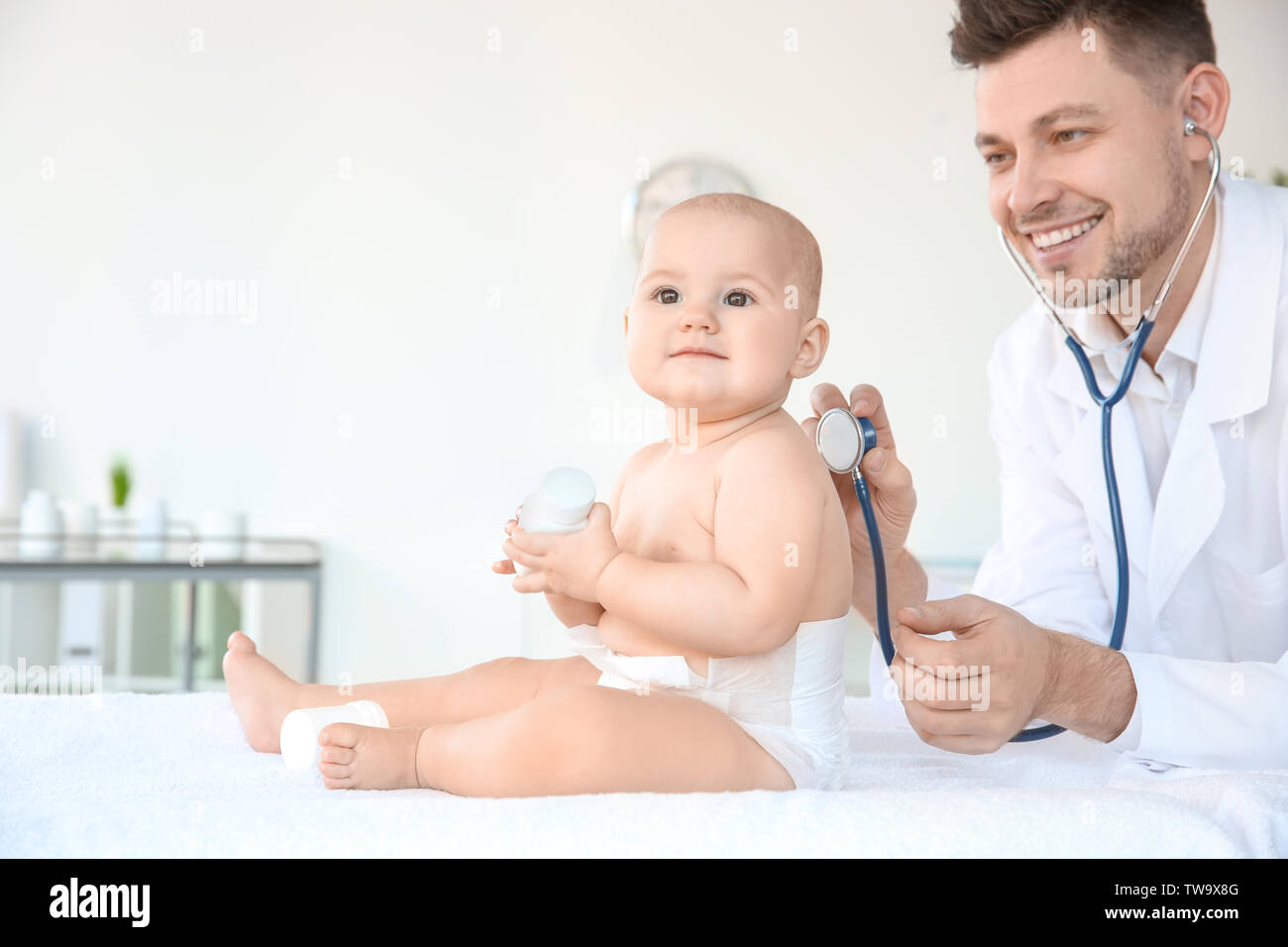 Doctor examining cute baby in clinic Stock Photo - Alamy