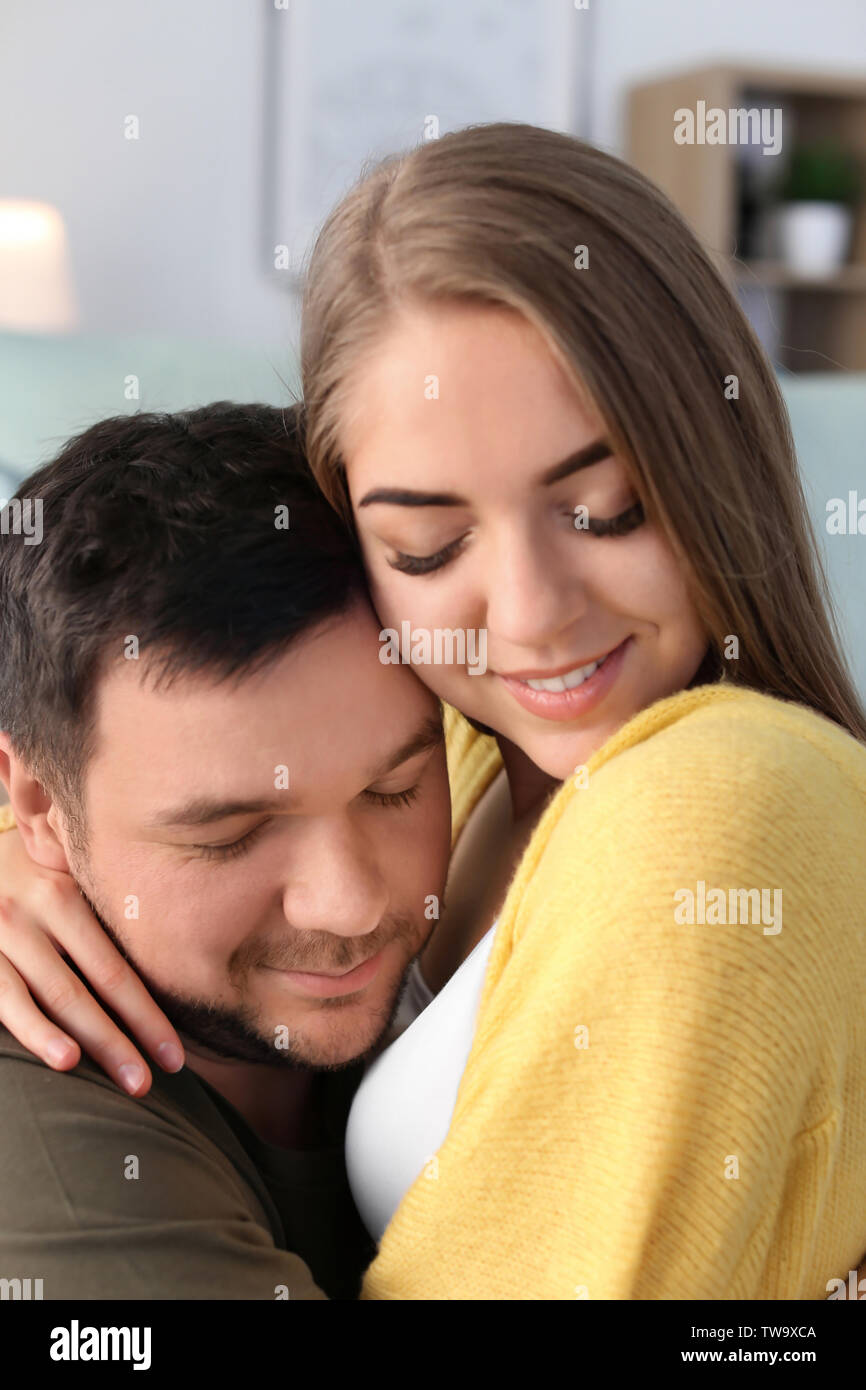 Cute young lovely couple hugging at home Stock Photo - Alamy