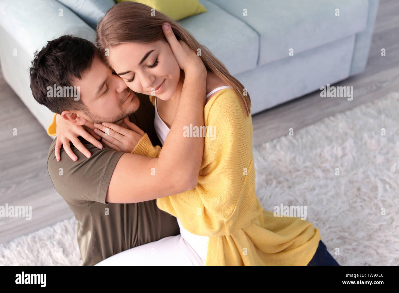 Cute young lovely couple hugging at home Stock Photo - Alamy