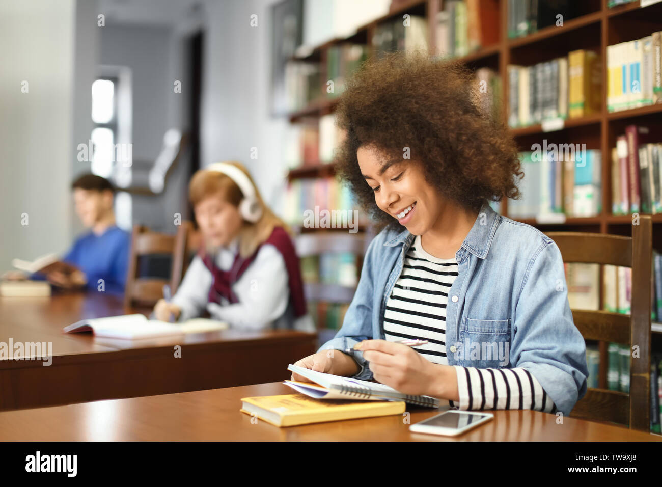 African American student studying in library Stock Photo - Alamy