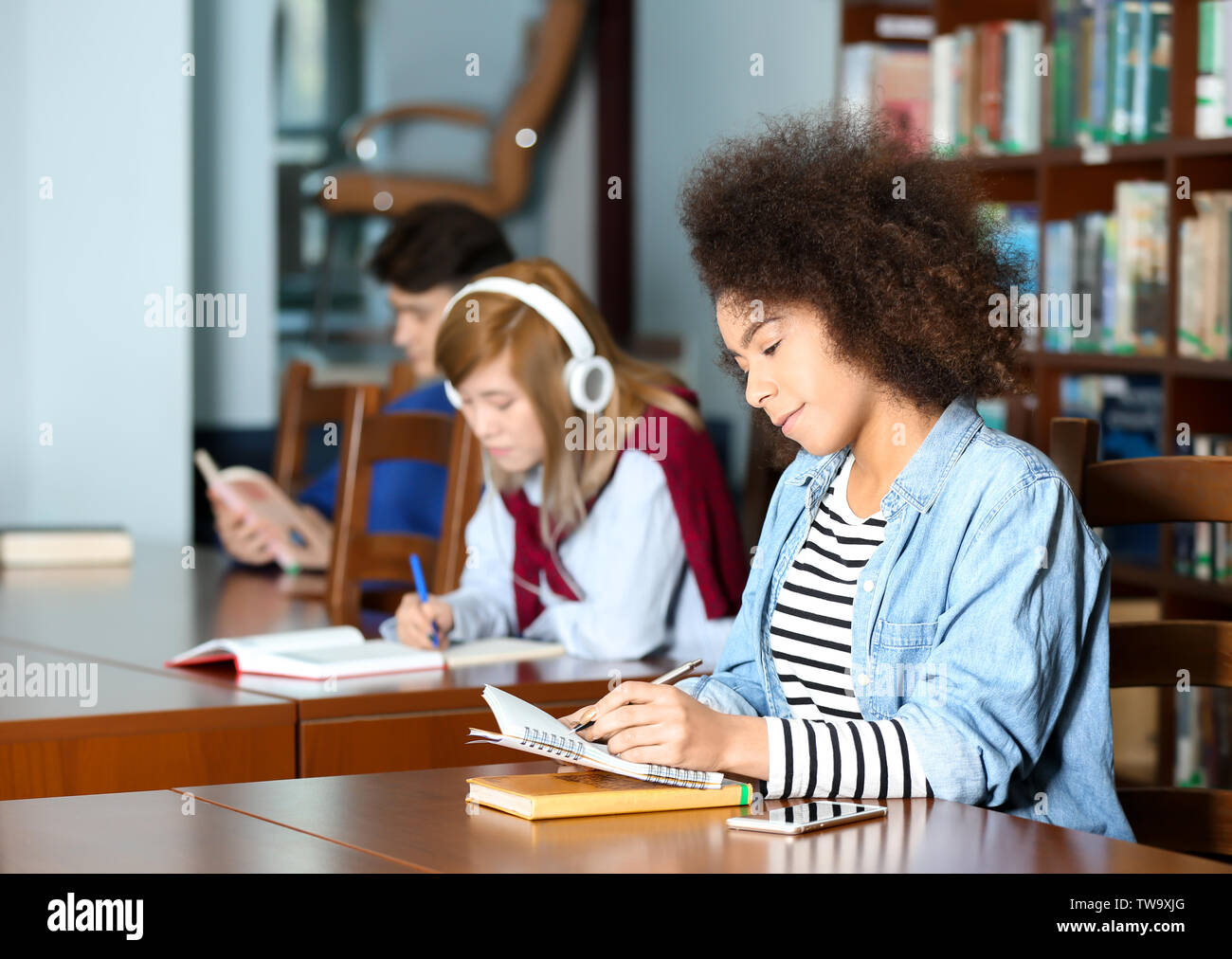 African American student studying in library Stock Photo - Alamy
