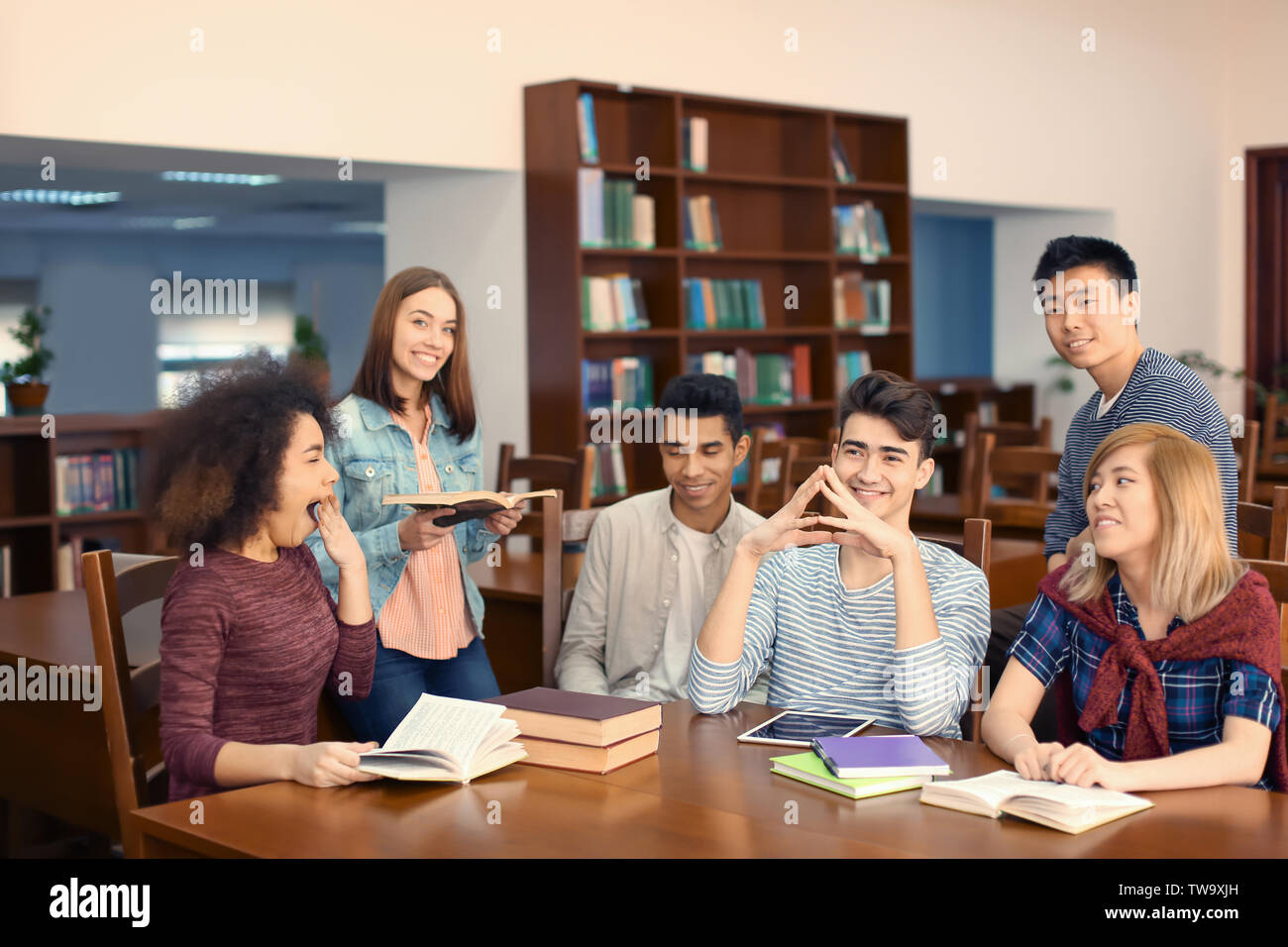 Group of students studying in library Stock Photo - Alamy