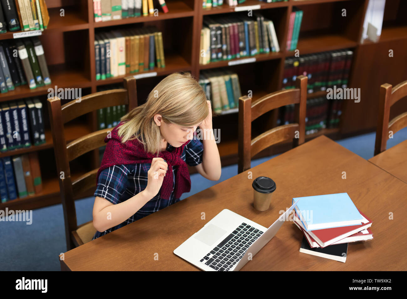 Asian student with laptop studying in library Stock Photo - Alamy