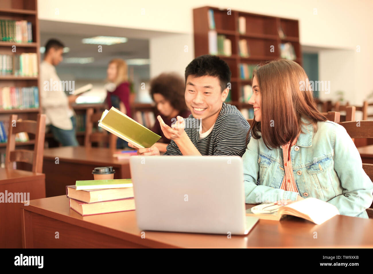 Students with laptop studying in library Stock Photo - Alamy