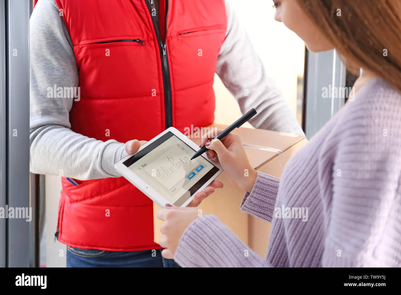 Woman signing on screen hi-res stock photography and images - Alamy