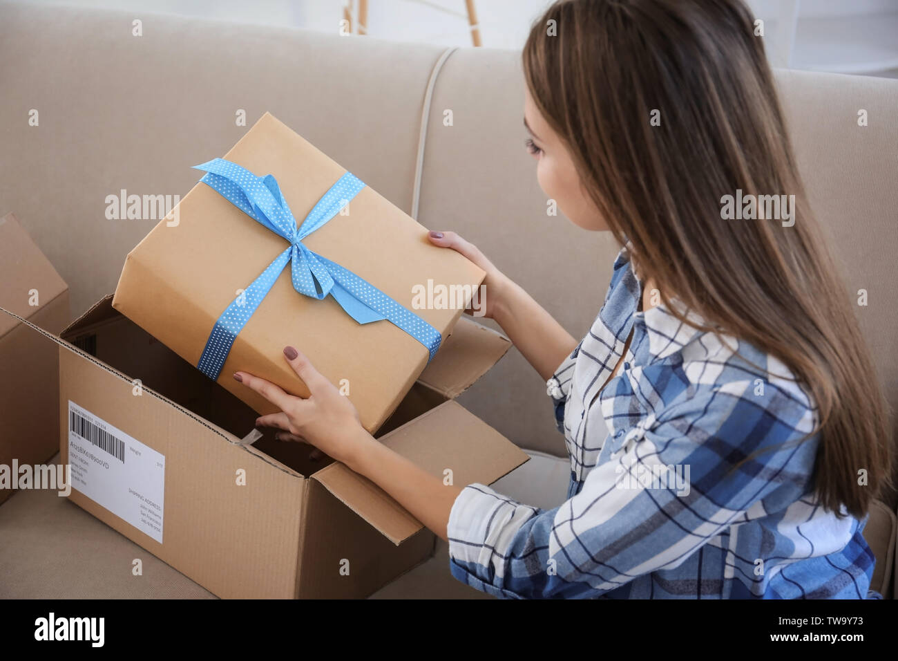 Woman opening parcel at home hi-res stock photography and images - Alamy