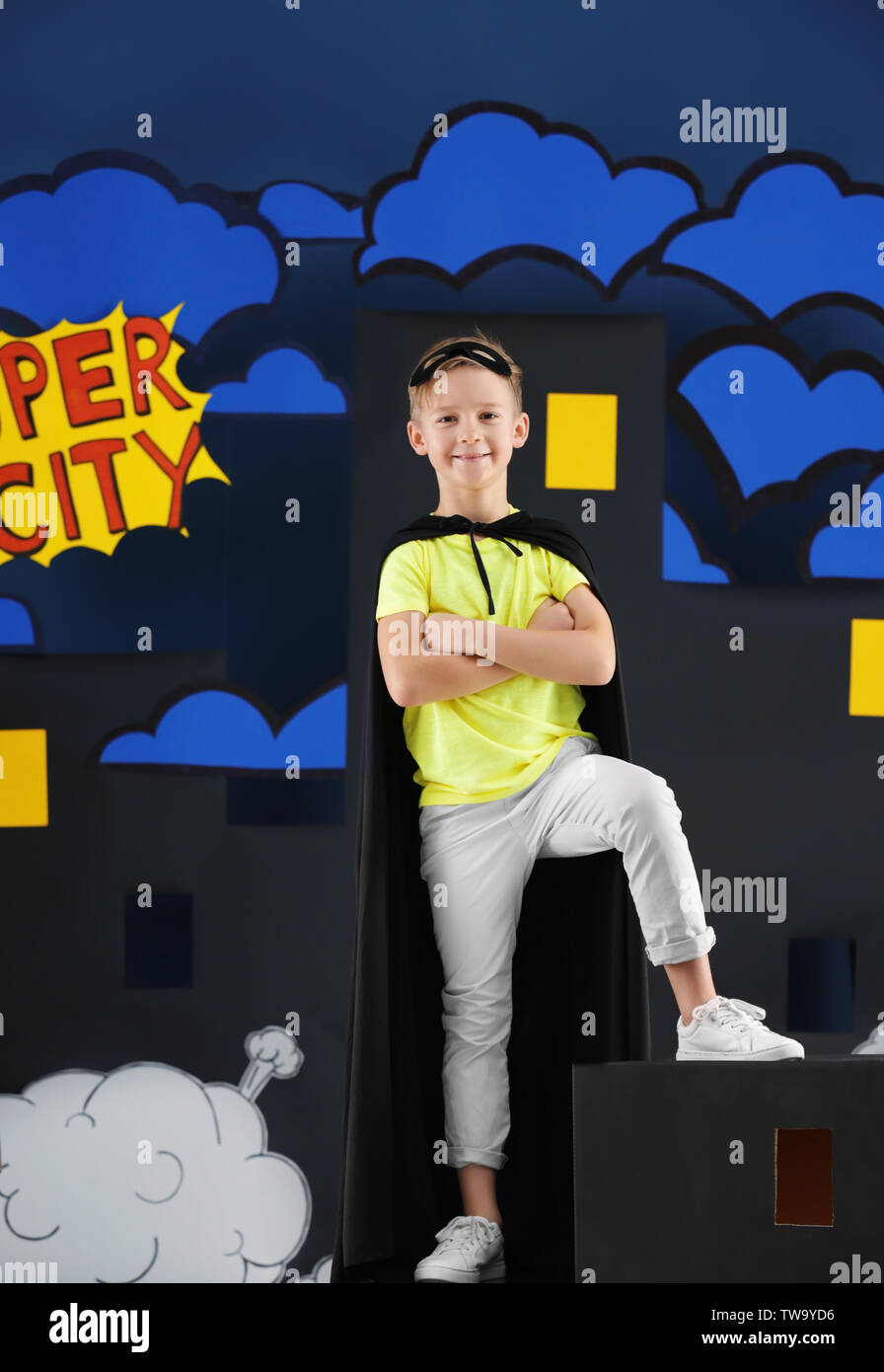 Cute boy as superhero against decoration. Comic strip city theme Stock ...