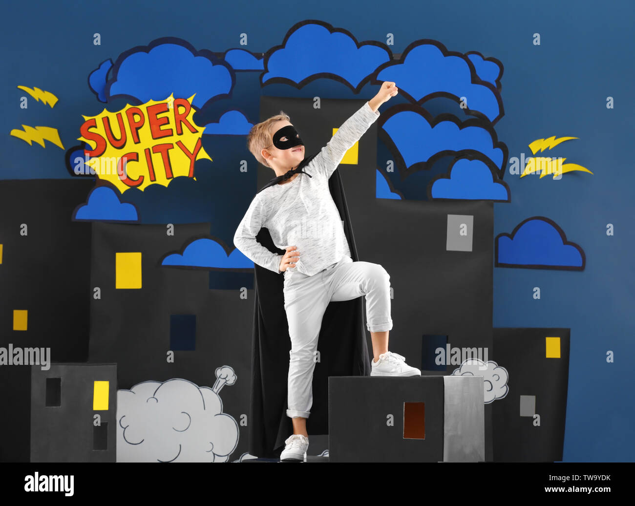 Cute boy as superhero against decoration. Comic strip city theme Stock ...