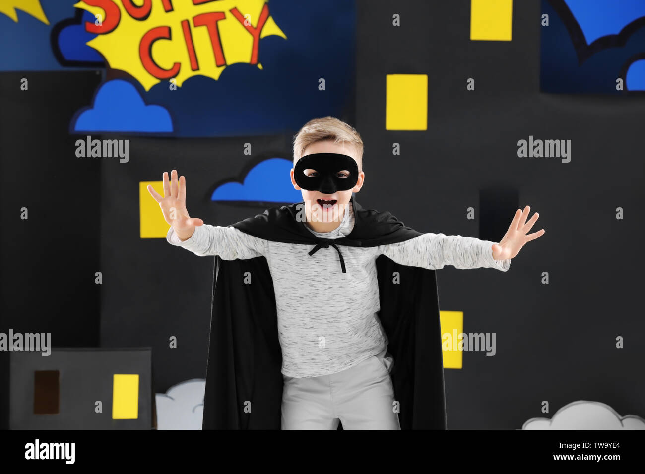 Cute boy as superhero against decoration. Comic strip city theme Stock ...
