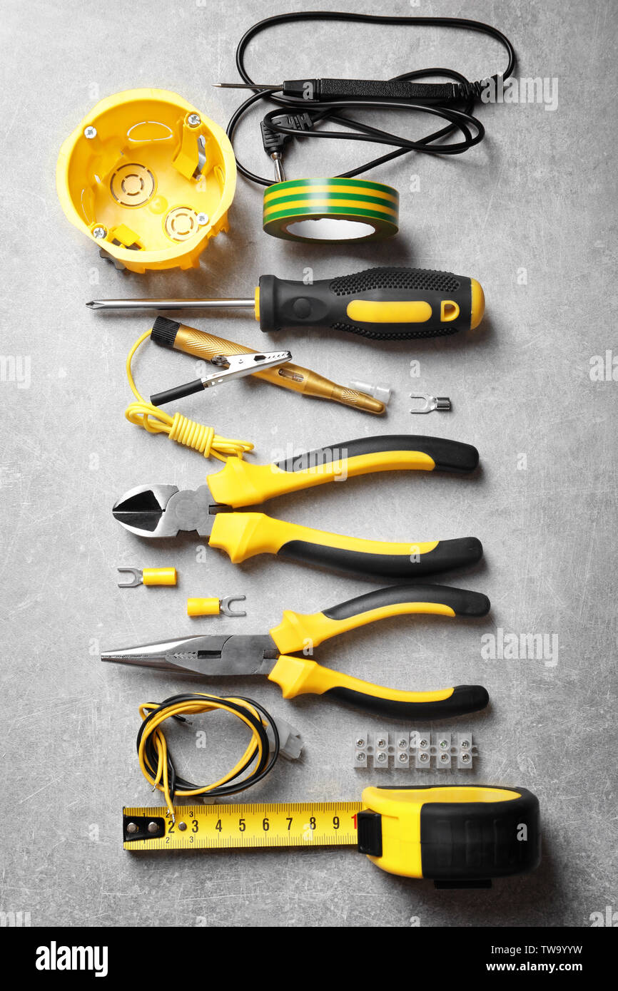 Different electrical tools on grey background Stock Photo - Alamy