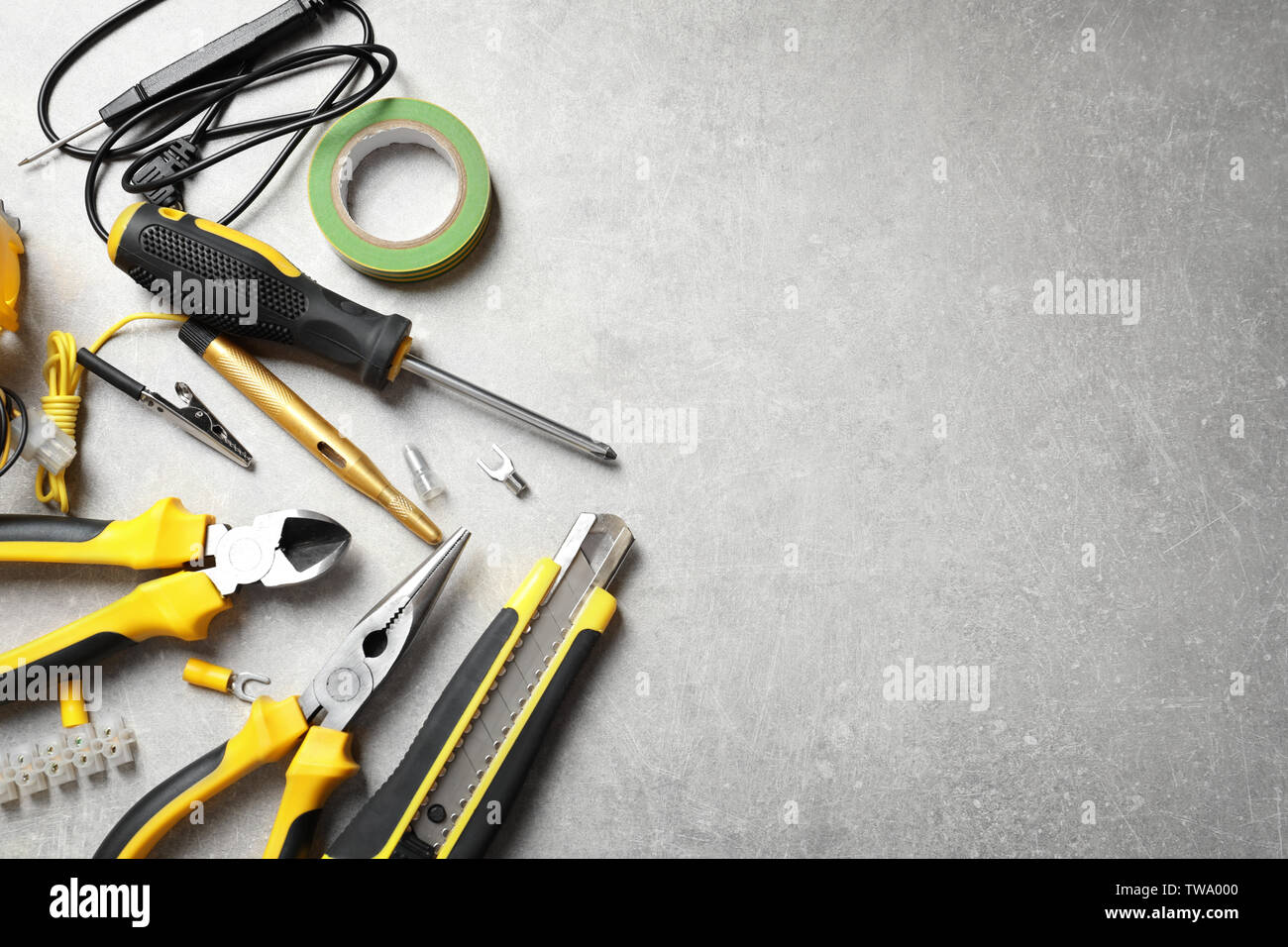 Different electrical tools on grey background Stock Photo - Alamy