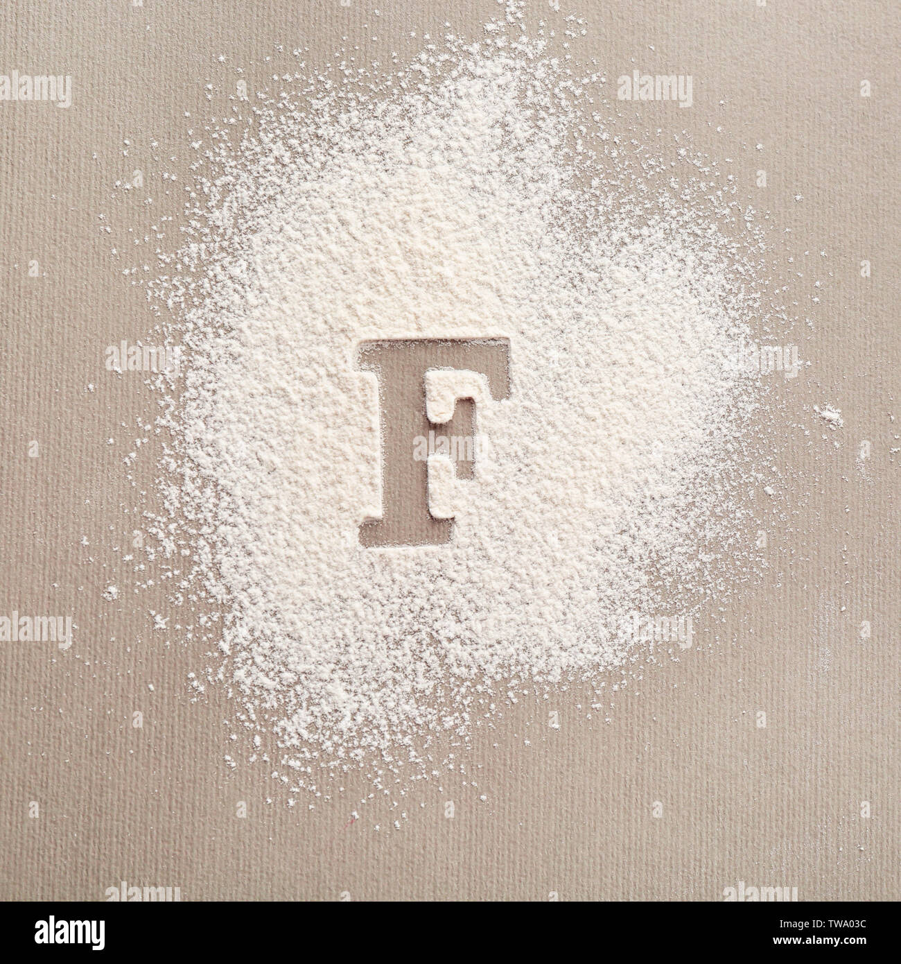 Silhouette of letter F on scattered flour Stock Photo - Alamy