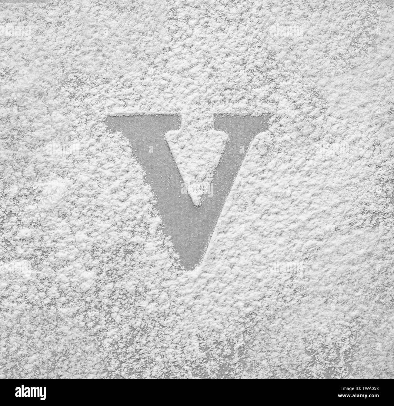 Silhouette of letter V on scattered flour Stock Photo - Alamy