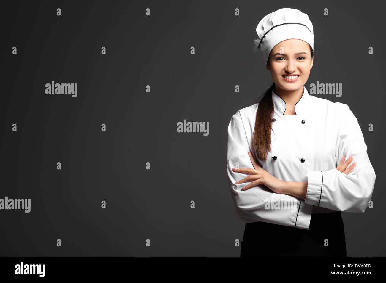 Beautiful female chef on dark background Stock Photo - Alamy