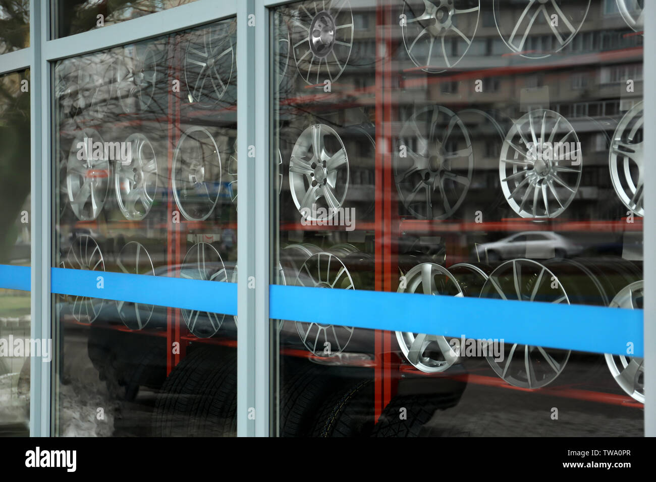 Showcase with tires and alloy wheels in modern store Stock Photo - Alamy