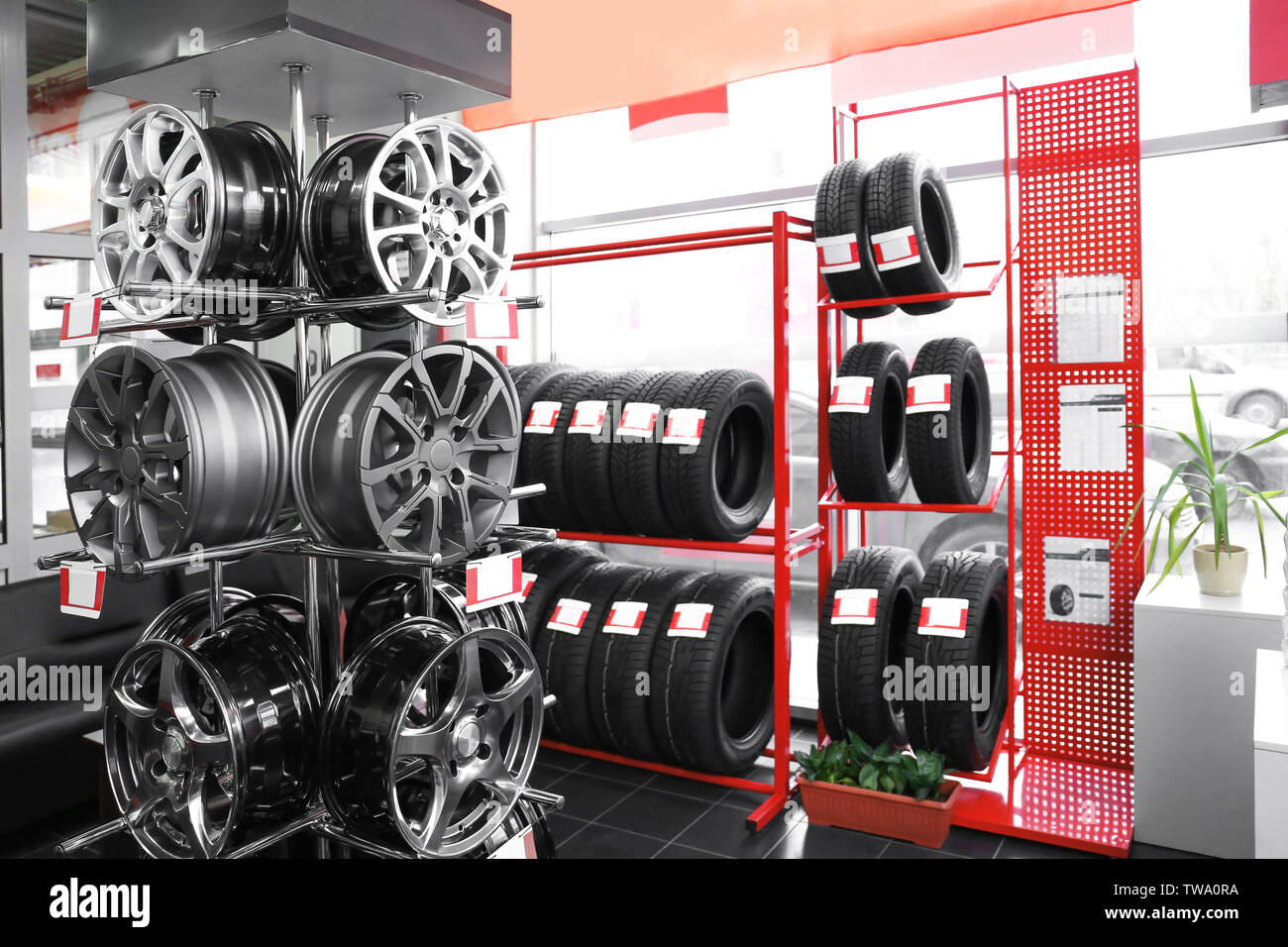 Modern store with alloy wheels and tires, indoors Stock Photo - Alamy