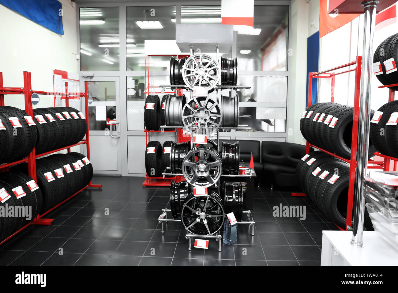 Modern store with alloy wheels and tires, indoors Stock Photo - Alamy