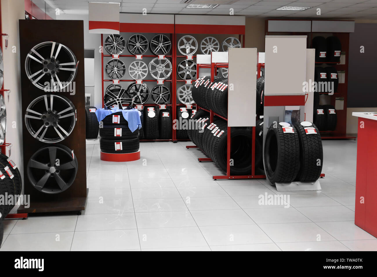 Modern store with alloy wheels and tires, indoors Stock Photo - Alamy
