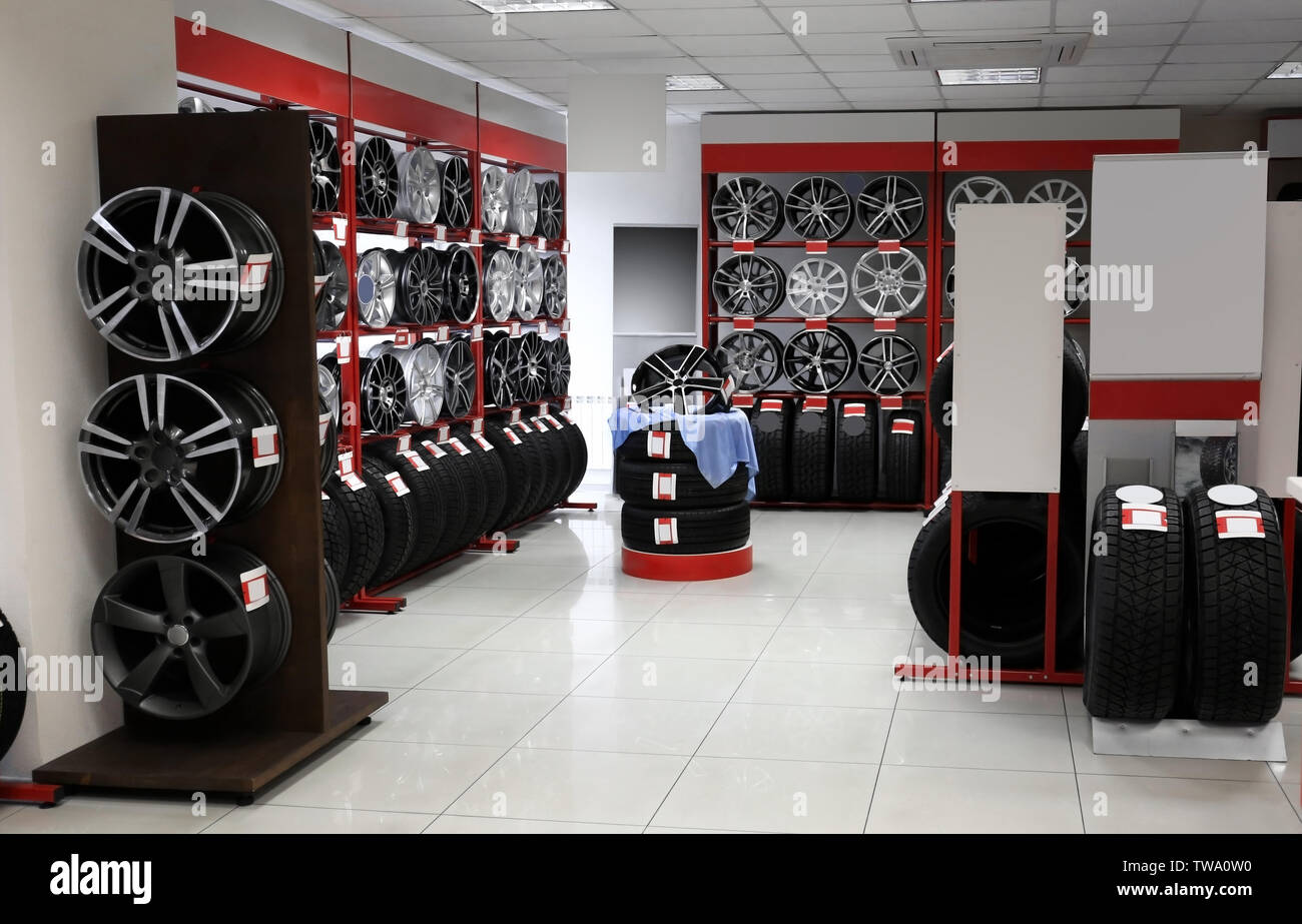 Modern store with alloy wheels and tires, indoors Stock Photo - Alamy