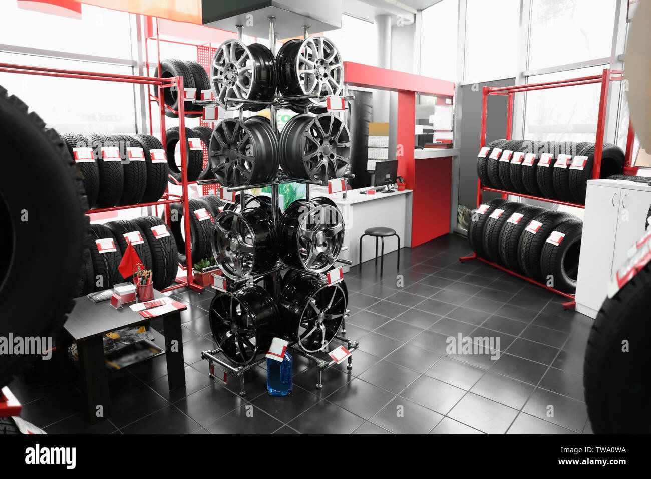 Modern store with alloy wheels and tires, indoors Stock Photo - Alamy