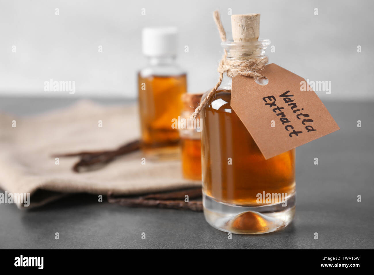 Glass bottle with vanilla extract on table Stock Photo - Alamy