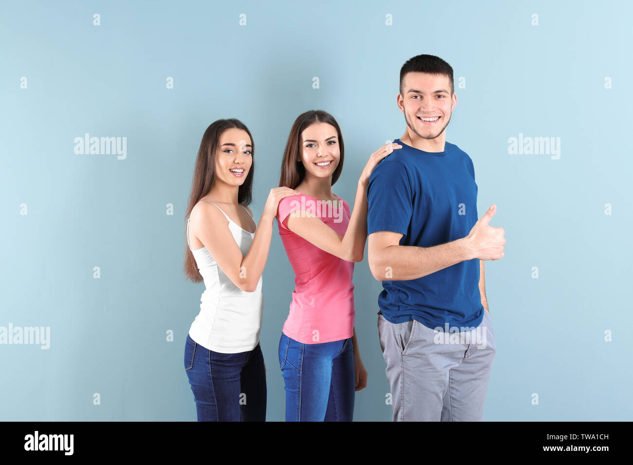 Young people posing together on color background. Unity concept Stock ...