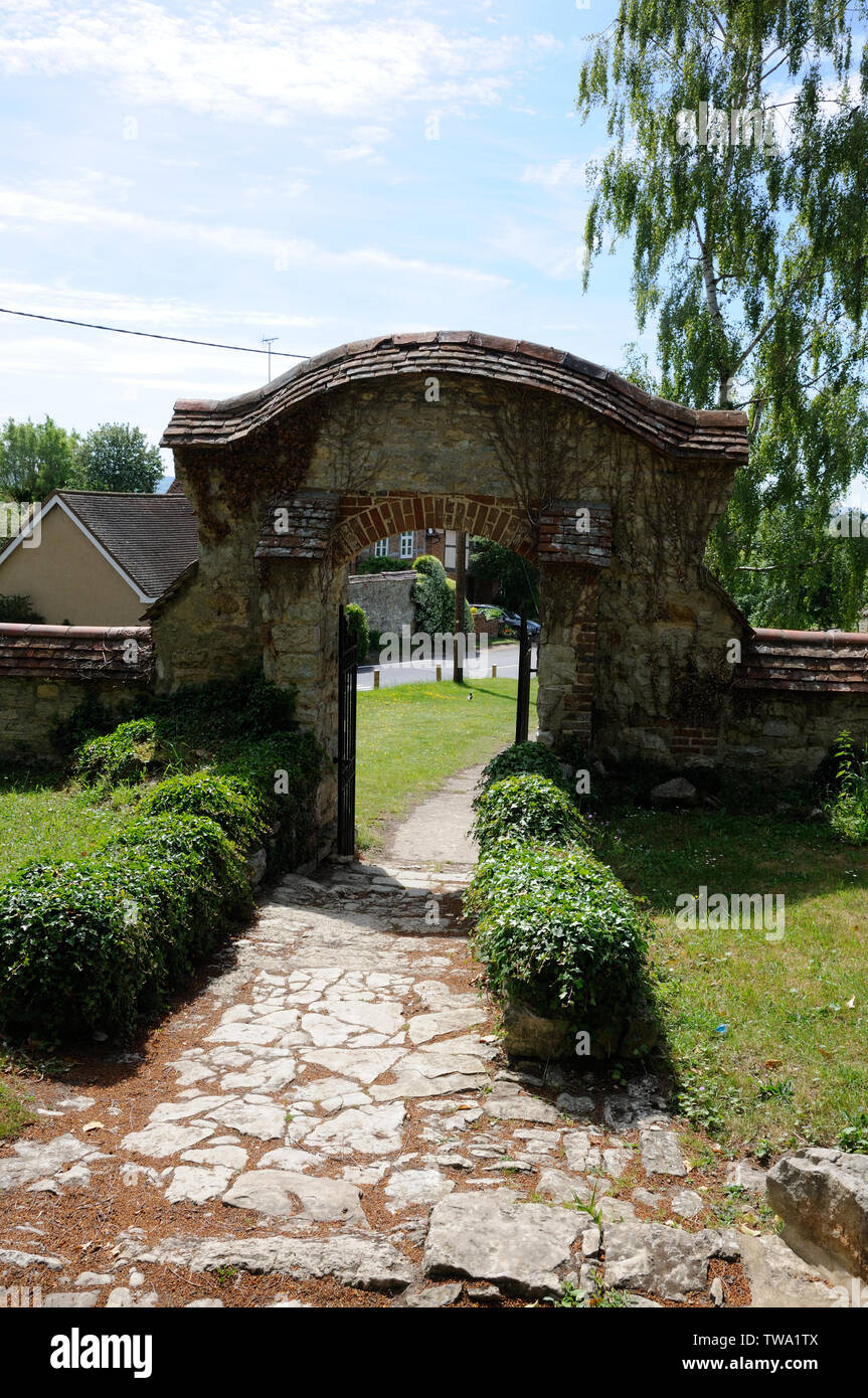 Archway through the stone churchyard wall of the church of St Peter ...