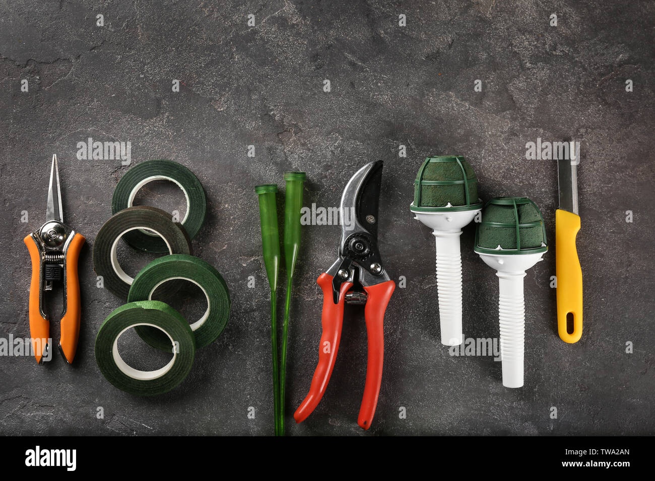 Florist equipment on grey background Stock Photo - Alamy