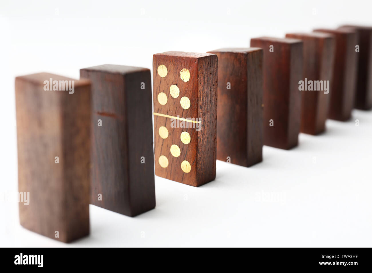 One domino standing out from others on white background. Think ...
