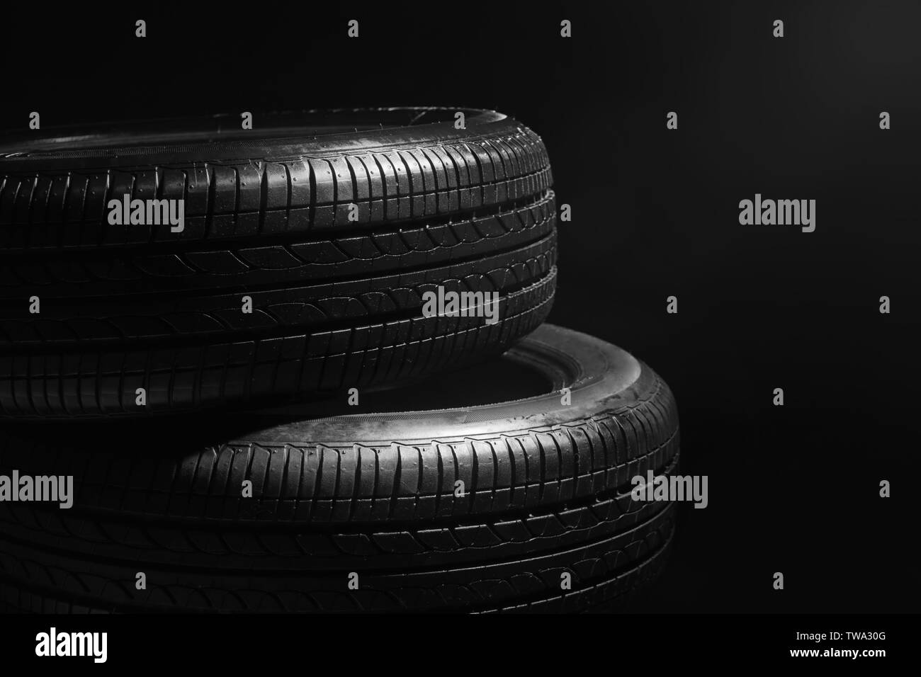 Black rubber tires stacked on Black and White Stock Photos & Images - Alamy