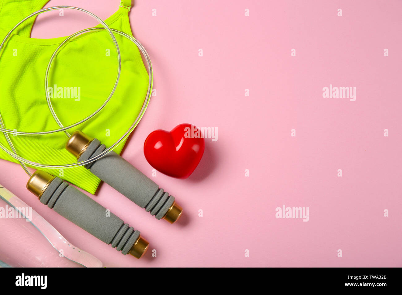 Gym stuff and red heart on color background. Cardio training concept ...