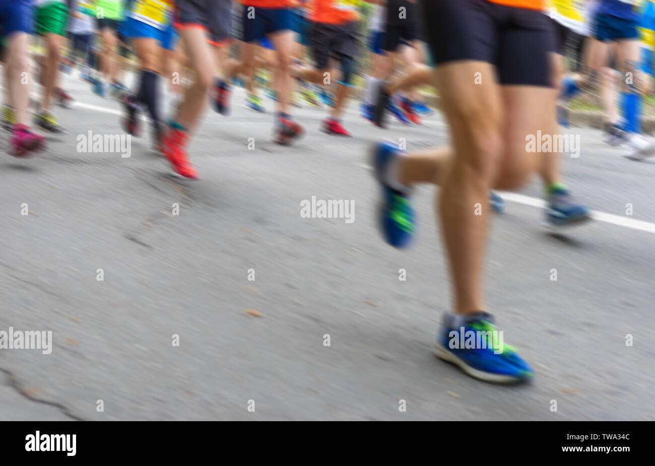 Blurry sport background - people feet running on an asphalt road during ...