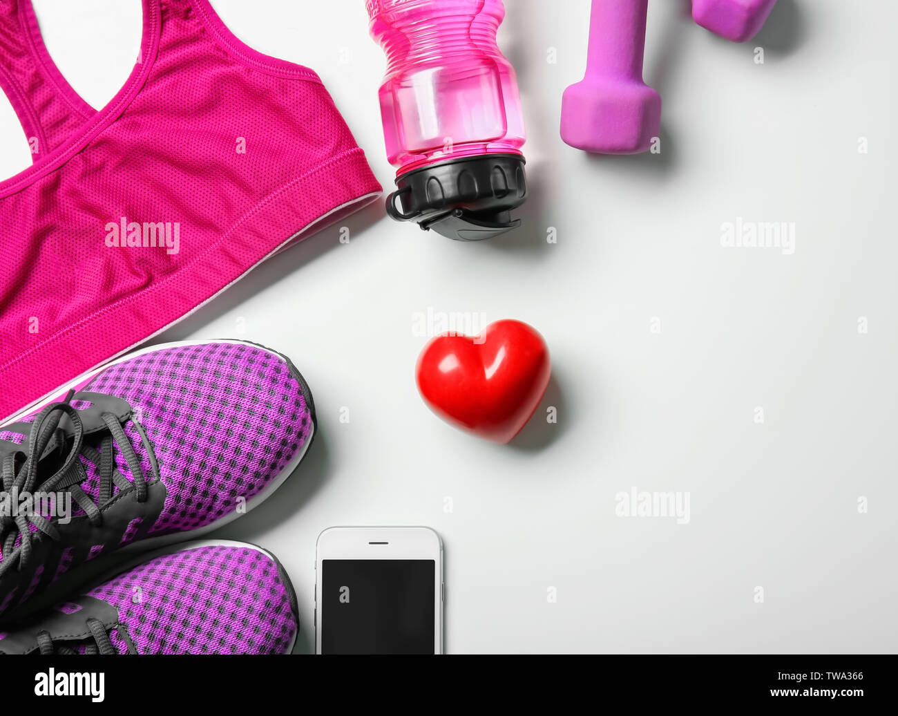 Gym stuff, phone and red heart on white background. Cardio training ...