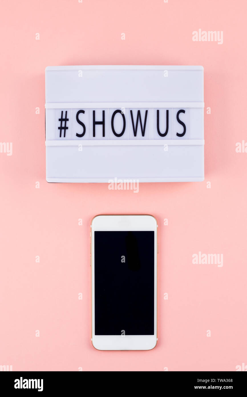 Creative top view flat lay of lightbox with hashtag Show Us message and ...