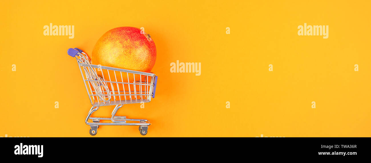 Mango fruit in shopping cart in creative conceptual top view flat lay ...