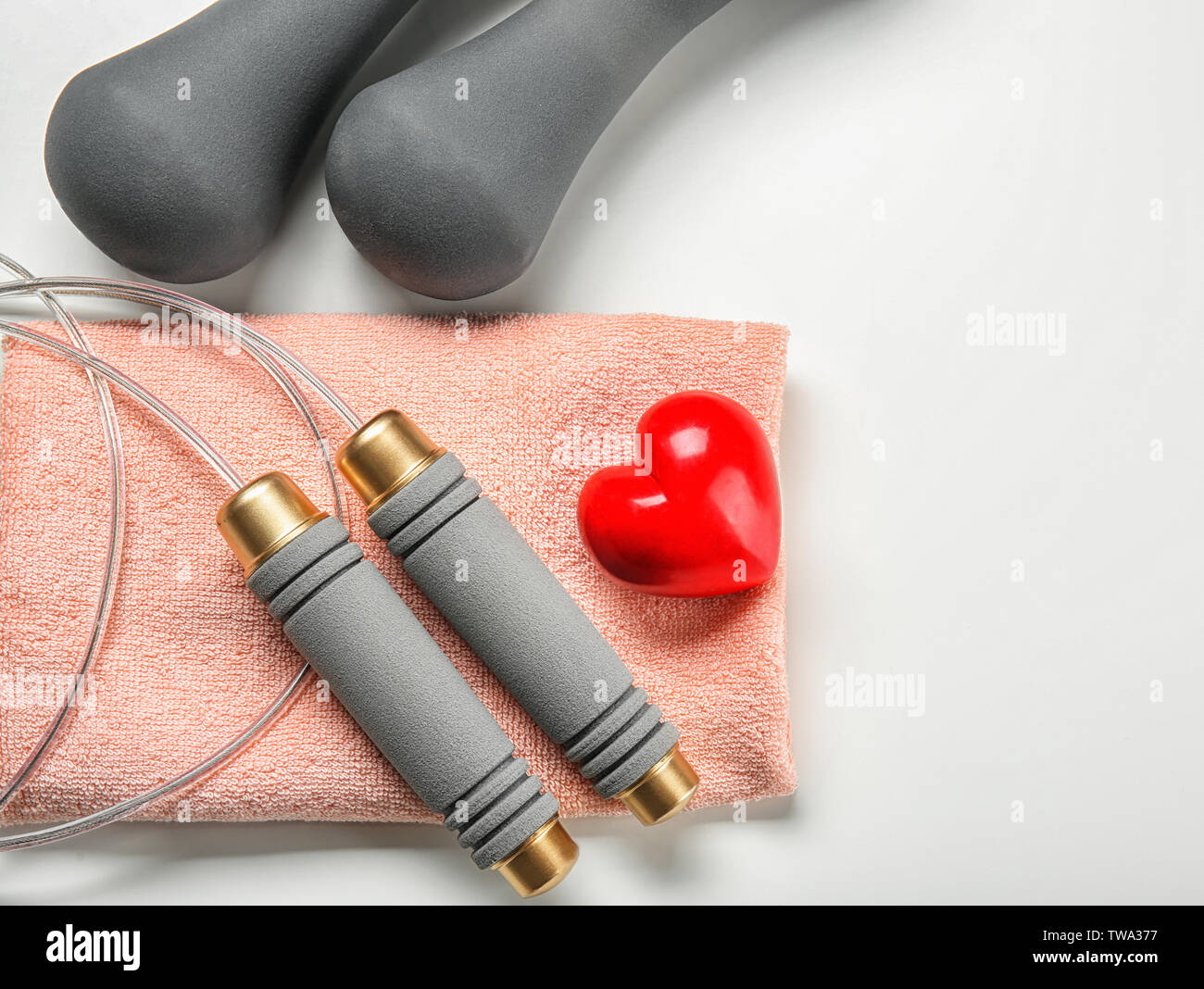 Gym stuff and red heart on white background. Cardio training concept ...