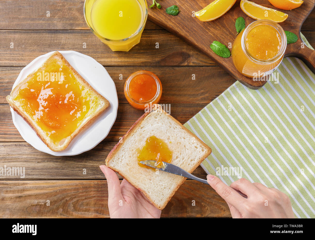 Woman spreading jam on toast hi-res stock photography and images - Alamy
