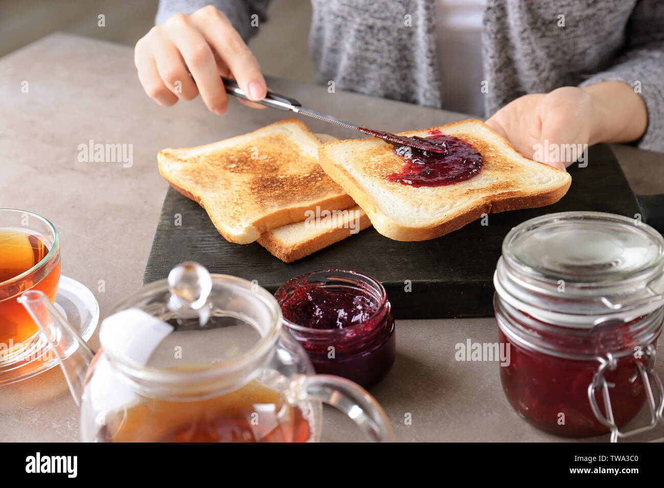 Woman spreading jam on toast hi-res stock photography and images - Alamy