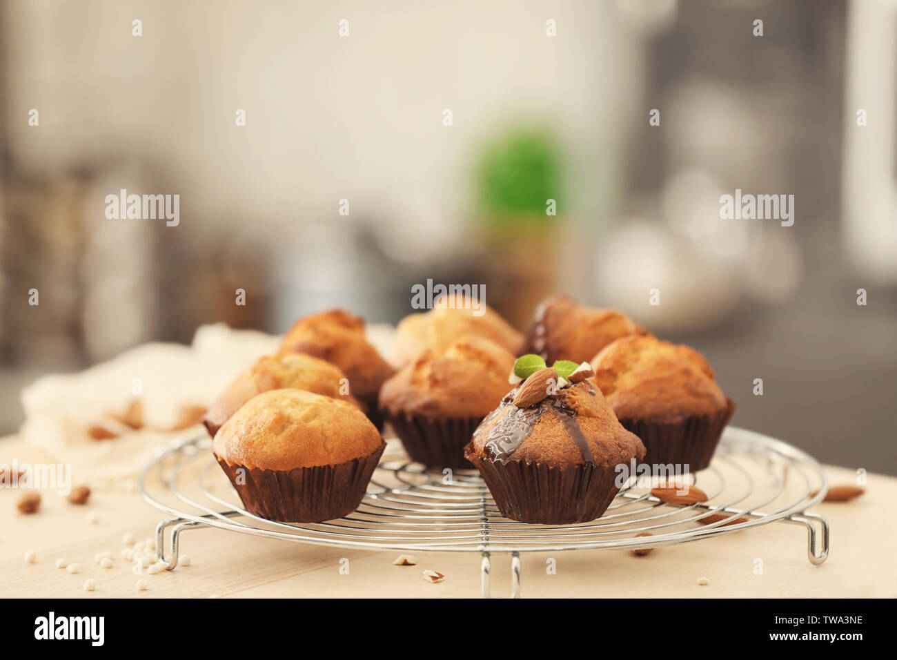 Cooling rack with tasty cupcakes on table Stock Photo - Alamy