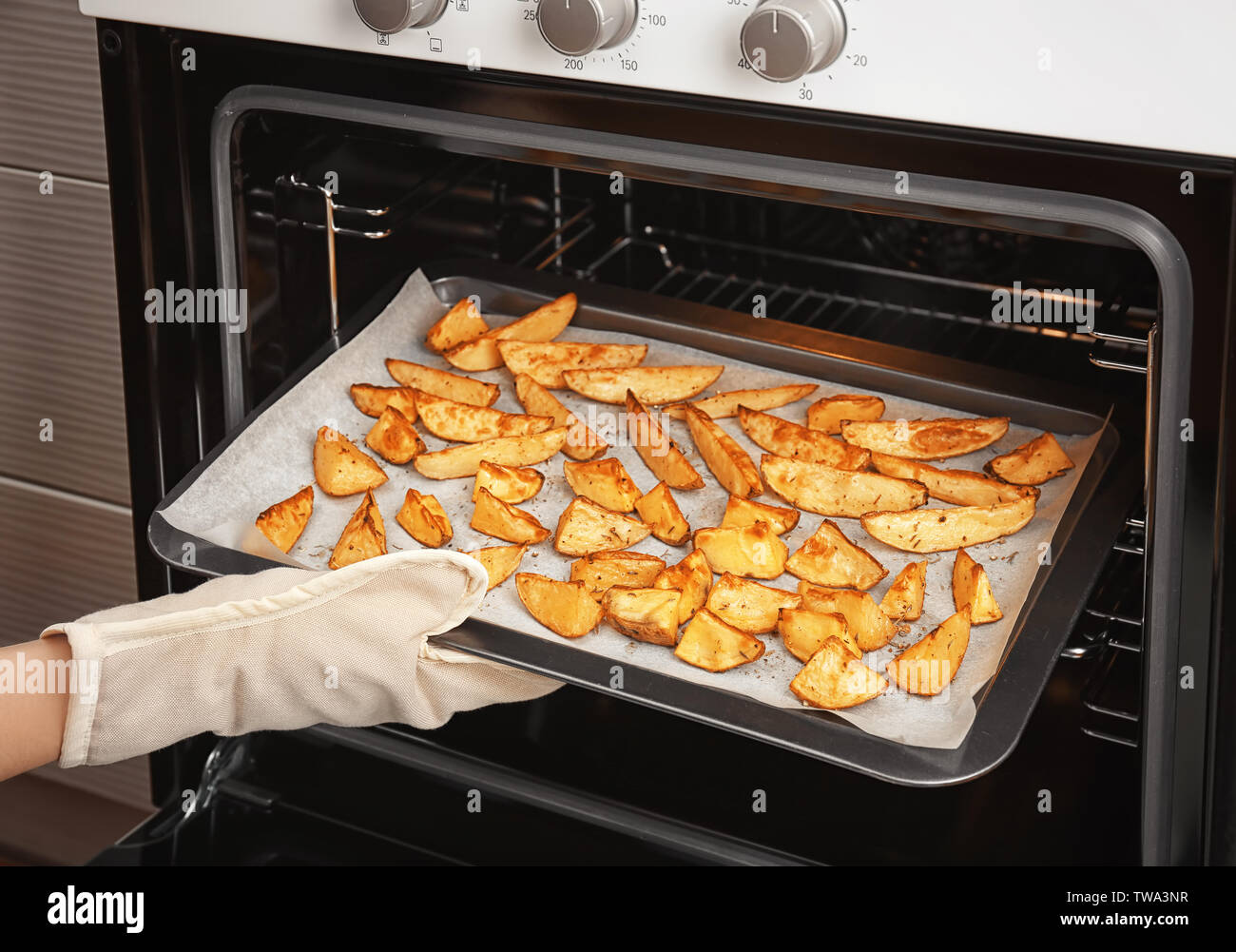 Woman taking baking sheet hi-res stock photography and images - Alamy
