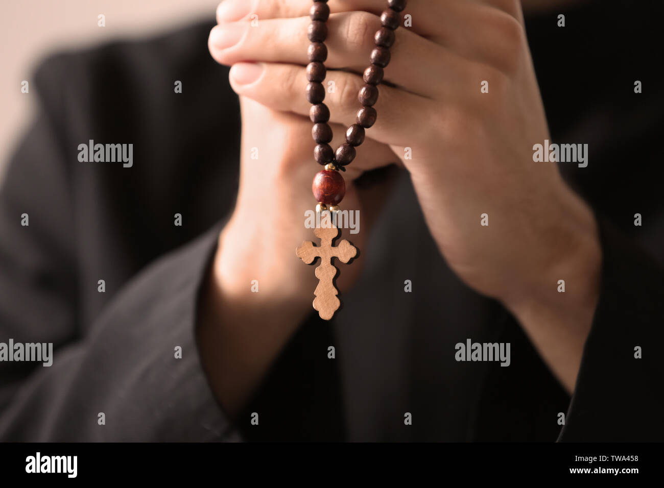Young catholic priest praying rosary hi-res stock photography and ...