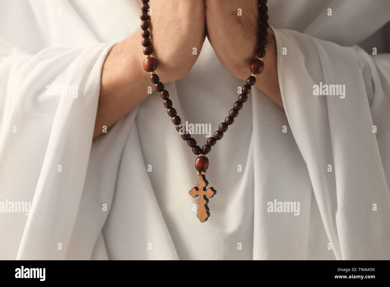 Praying monk with rosary beads, closeup Stock Photo - Alamy