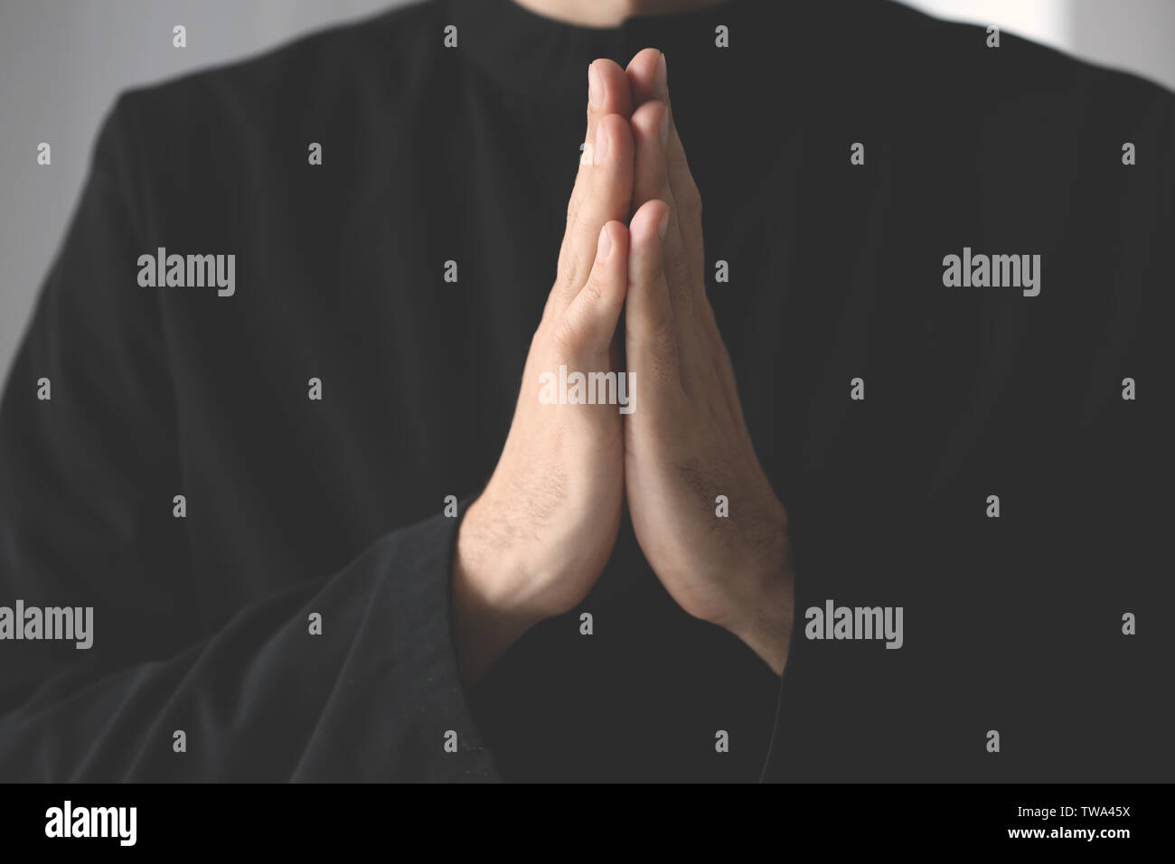 Young priest praying to God, closeup Stock Photo - Alamy